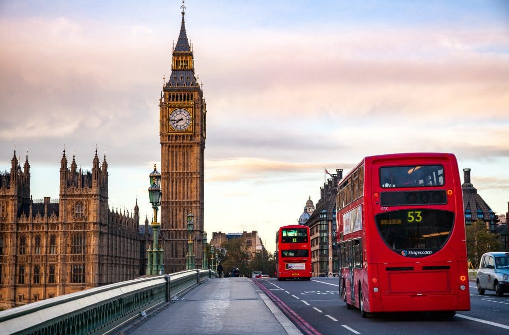 London traffic scene with Double Decker buses move along the Wes ...